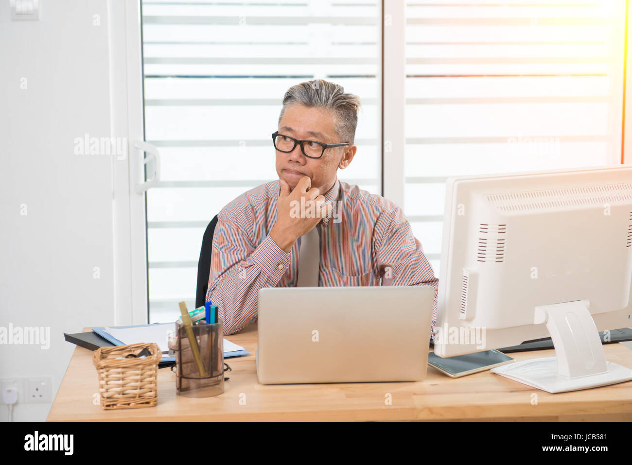 asian business senior male thinking Stock Photo - Alamy