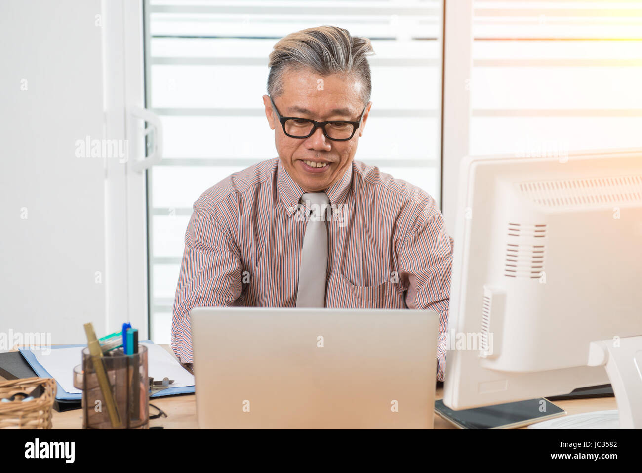 senior asian male at work Stock Photo - Alamy