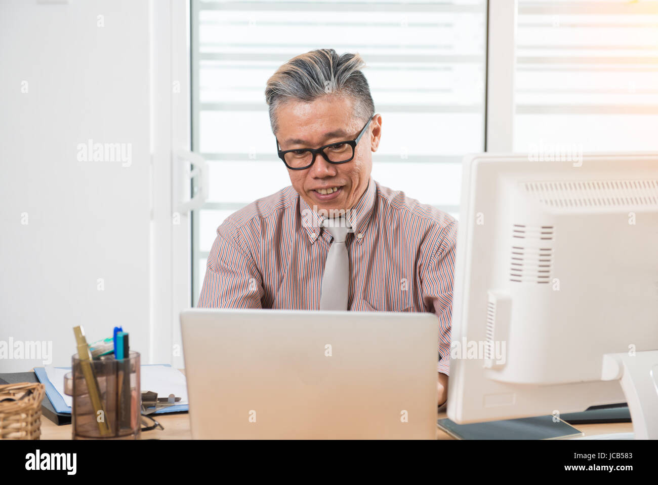 senior asian male at work Stock Photo - Alamy
