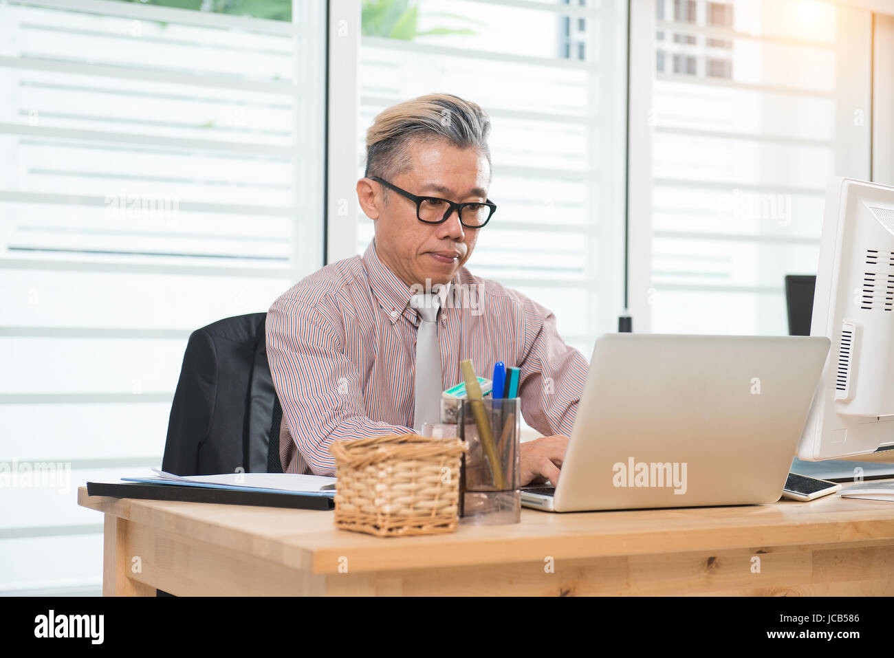 senior asian male at work Stock Photo - Alamy