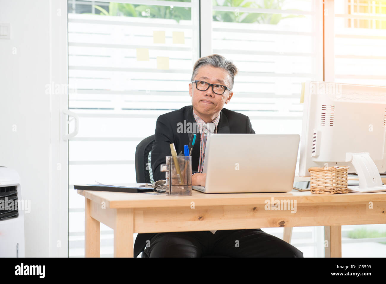 asian business senior male thinking Stock Photo - Alamy