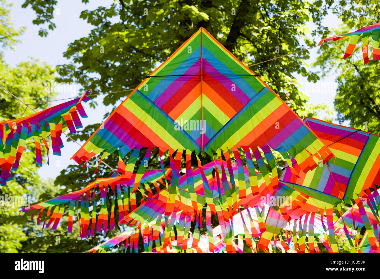 bright colorful kites hangged as decoration with green background Stock ...