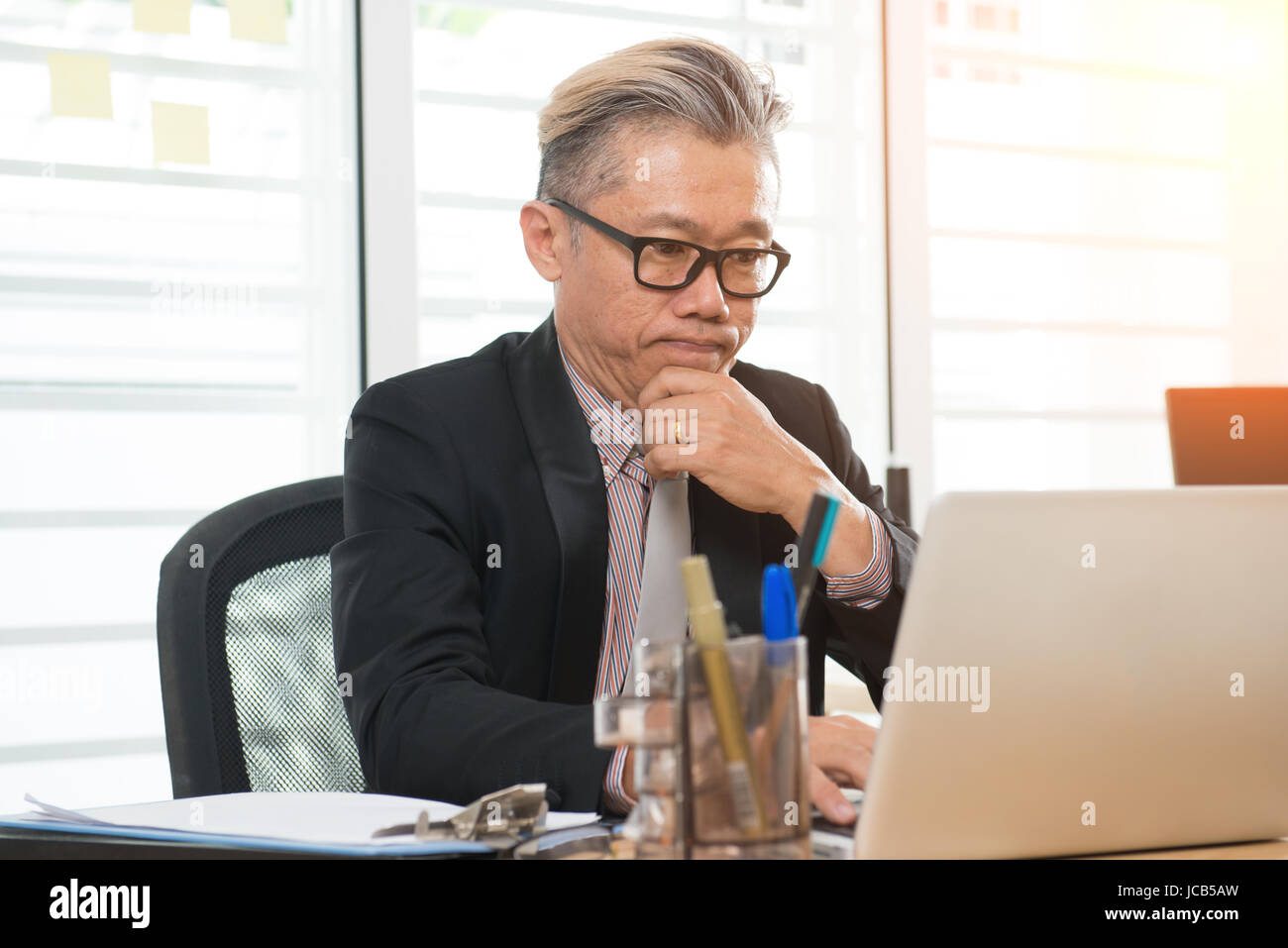 asian business senior male thinking Stock Photo - Alamy
