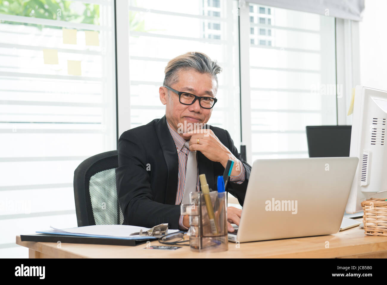 senior asian male at work Stock Photo - Alamy