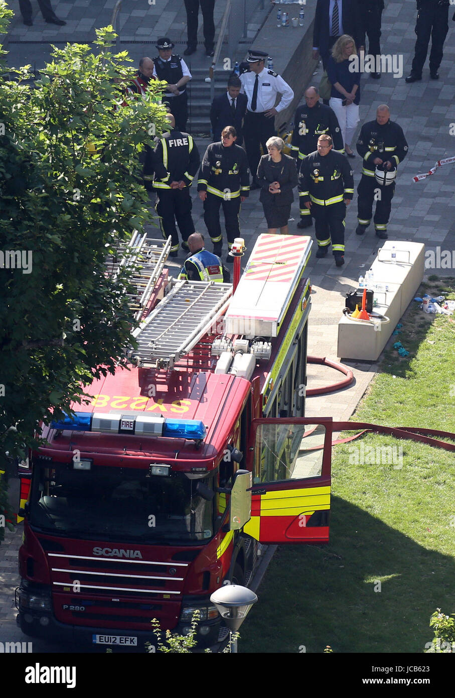 Prime Minister Theresa May speaks with London Fire Commissioner Dany ...