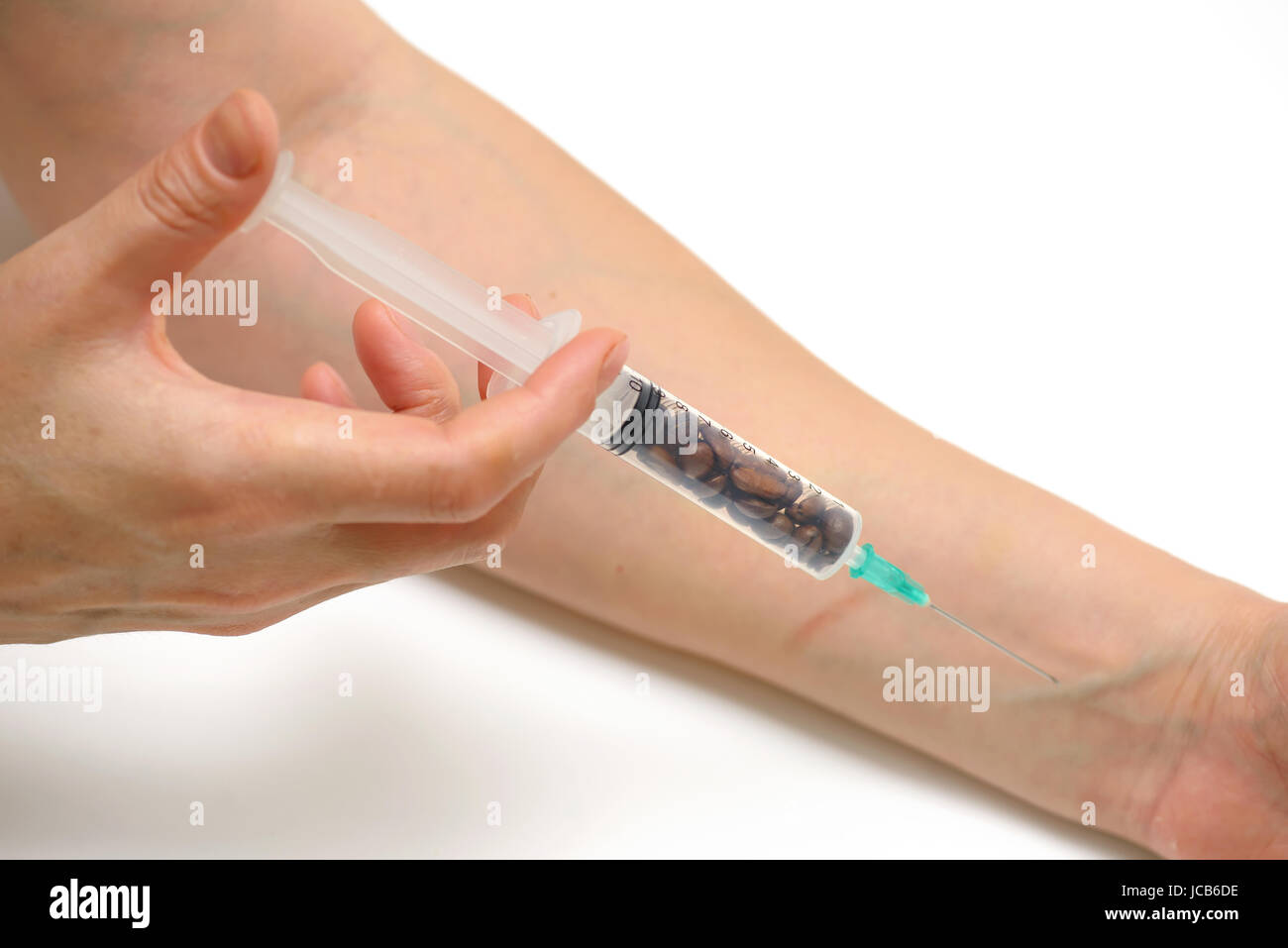 Coffee beans in syringe acting injection Stock Photo - Alamy