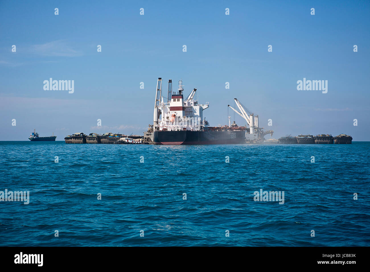 A huge transporter ship at the construction site in the sea of Thailand ...