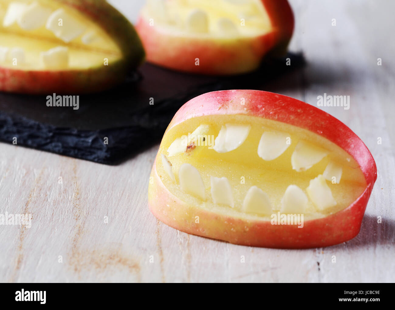 Creative Halloween apple with teeth in a cutout shape with an open ...