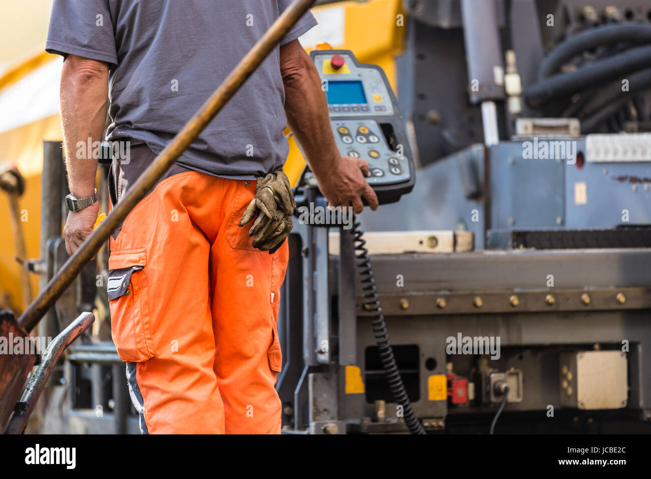 Construction workers during asphalting road works. Manual labor Stock ...