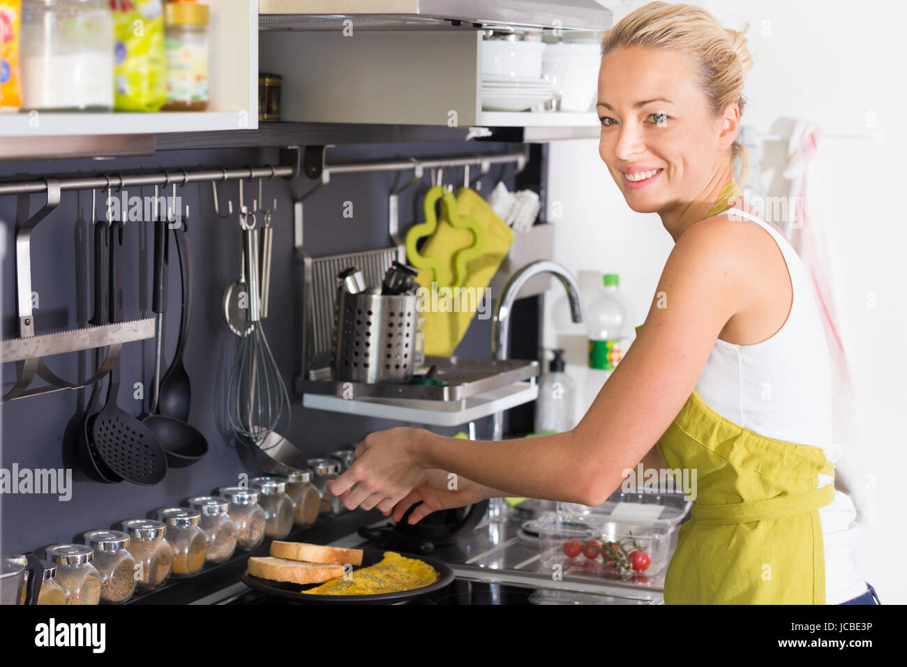 Young Woman Cooking. Healthy Mediterranean Breakfast - Home Made Egg ...
