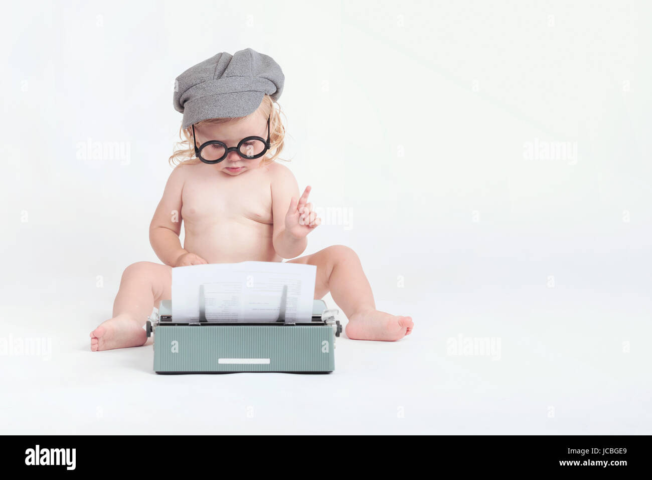 Little baby typing with a typewriter Stock Photo - Alamy