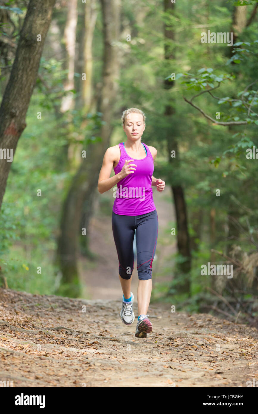 Pretty young girl runner in the forest. Running woman. Female Runner ...