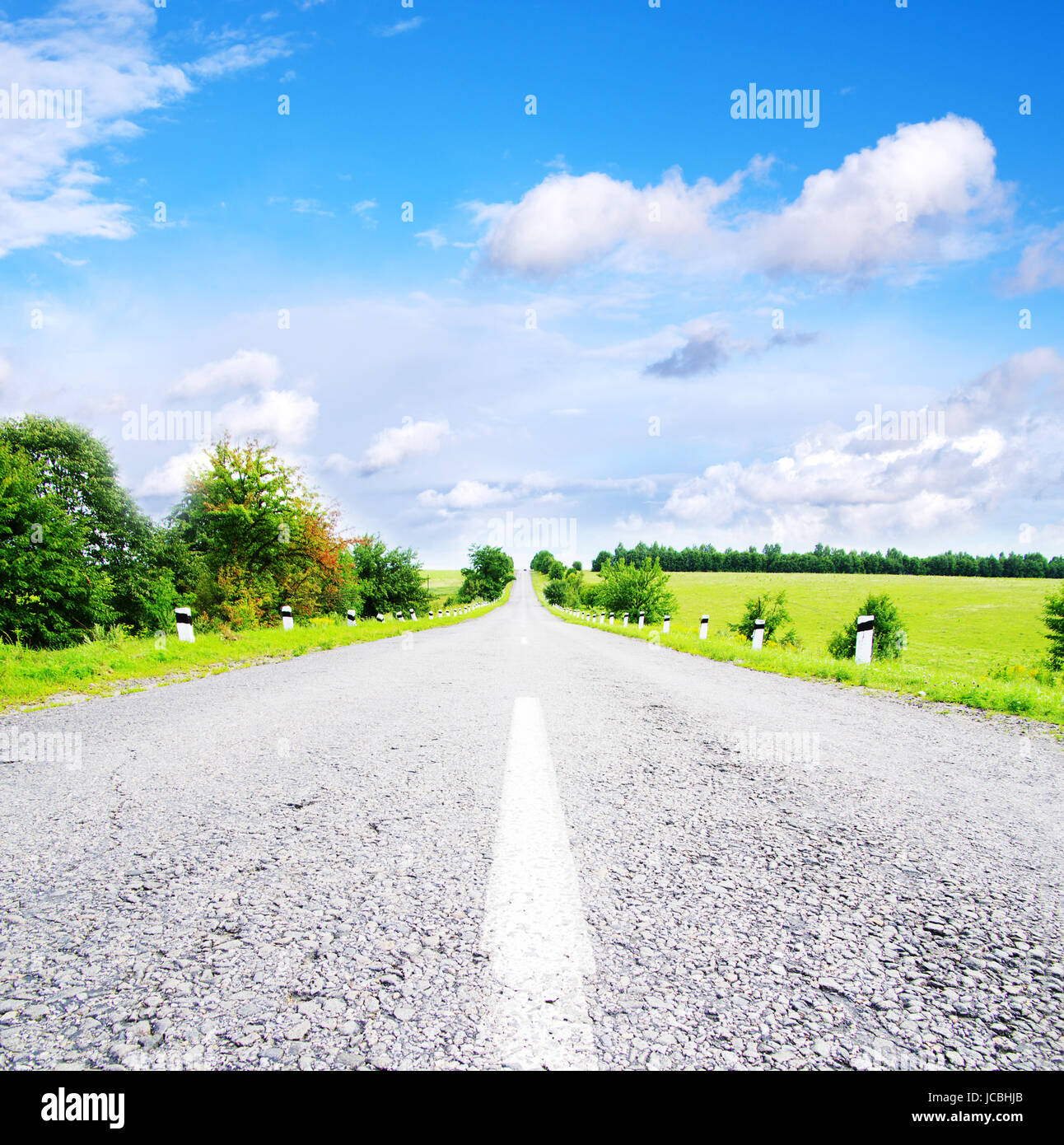 green field and along road Stock Photo - Alamy
