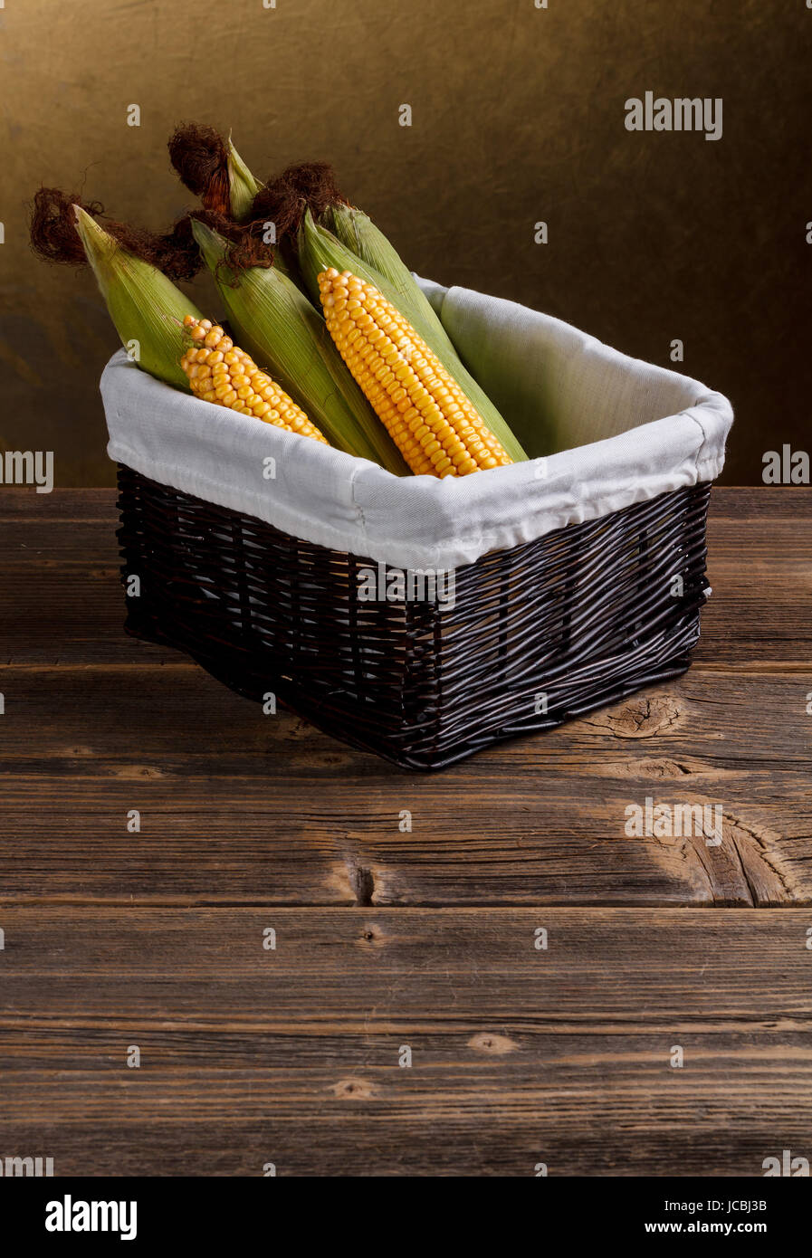 Corn cobs on basket with a rustic wood planks background Stock Photo ...