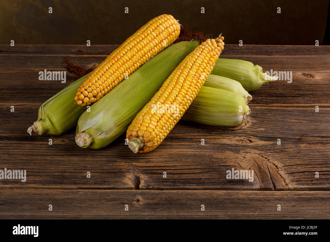 Corn cobs on rustic wooden board Stock Photo - Alamy