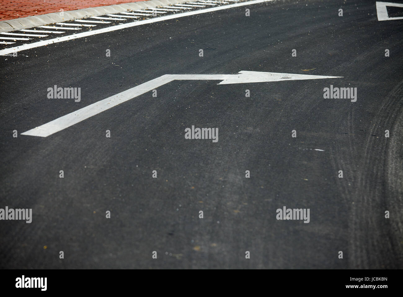 Arrow sign on the asphalt road Stock Photo - Alamy