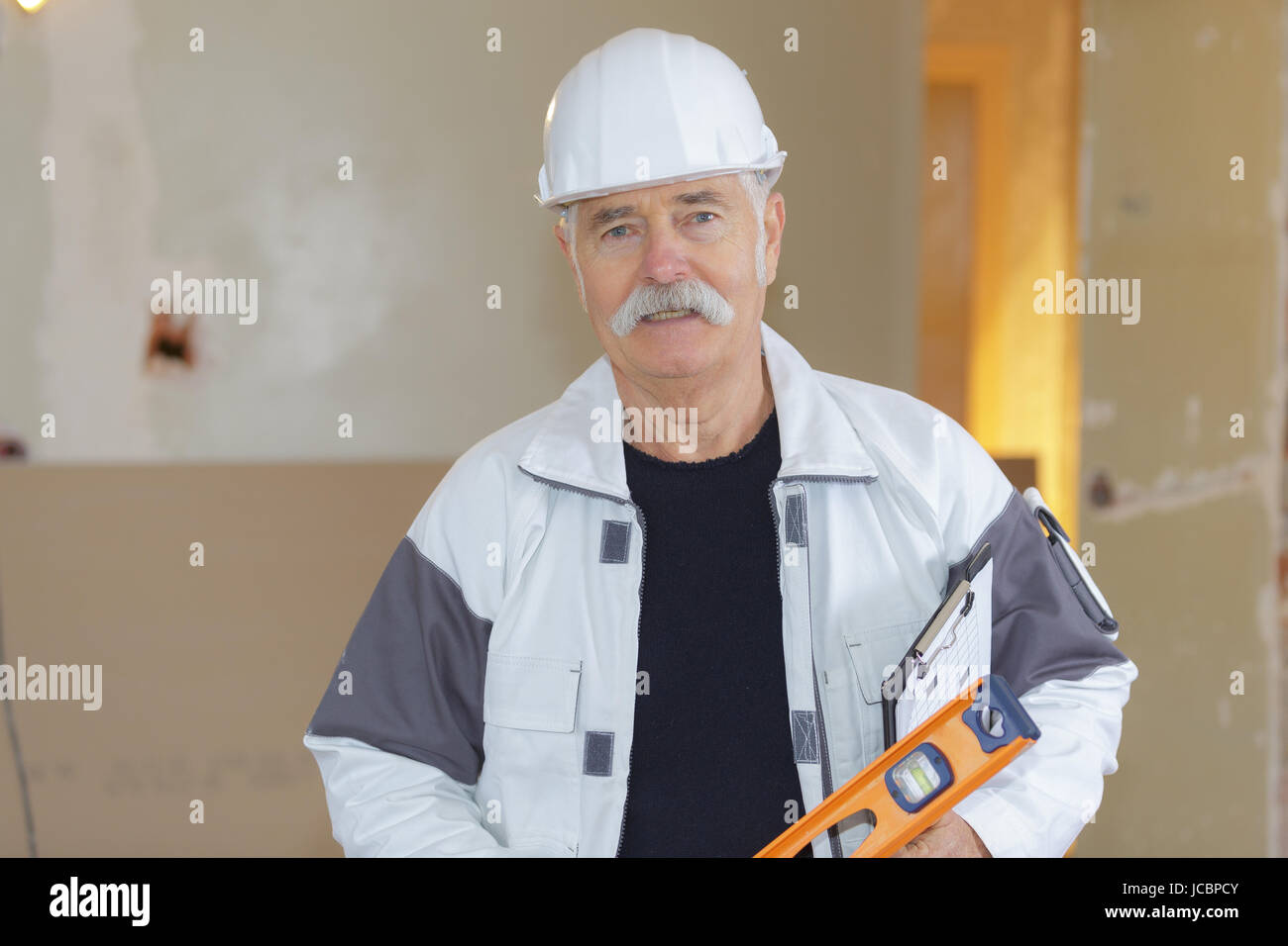 builder posing on construction site Stock Photo - Alamy