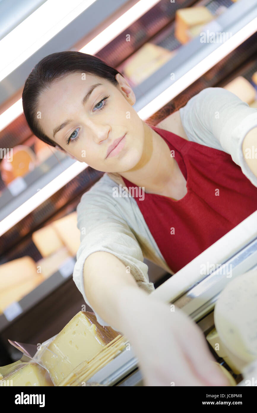 happy woman selling various cheese Stock Photo - Alamy