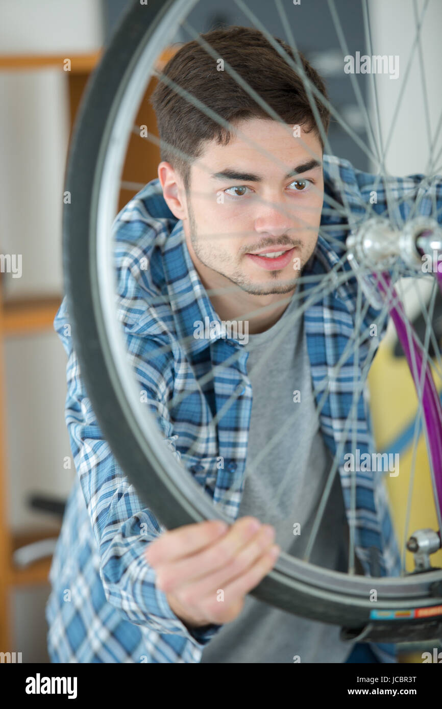 Man working on bicycle wheel Stock Photo - Alamy