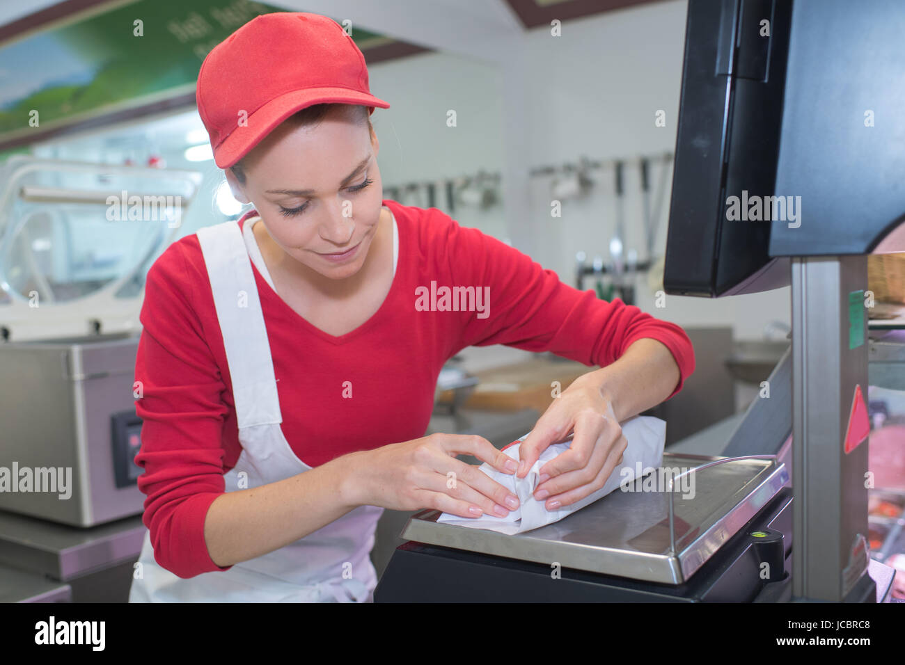 portrait of beautiful butcher packing meat in paper at shop Stock Photo ...
