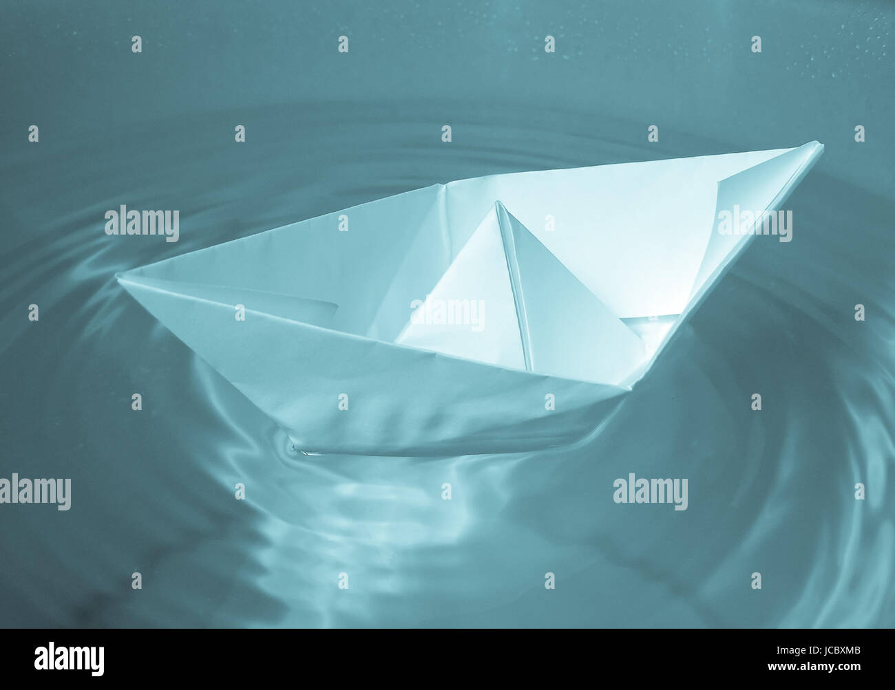 A picture of Paper ship in water - cool cyanotype Stock Photo - Alamy