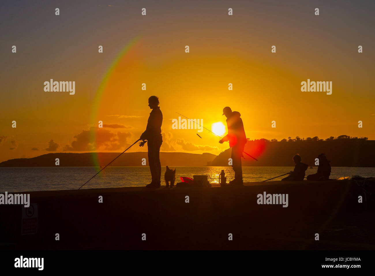 Mid adult man fishing off pier hi-res stock photography and images - Alamy