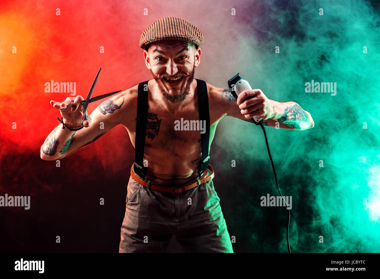 Stylish tattooed shirtless barber gangsta man with razor looking at ...