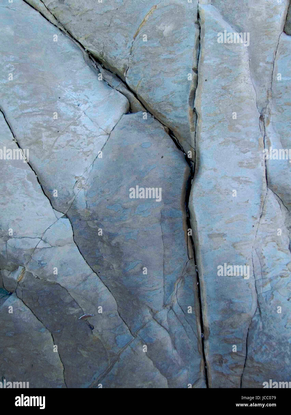 Natural Shiny Blue Rocks with Huge Crevice Stock Photo - Alamy