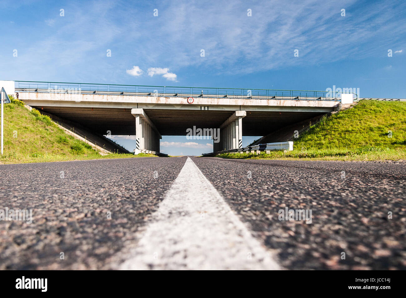 Bridge over the rural road at sunny day Stock Photo - Alamy