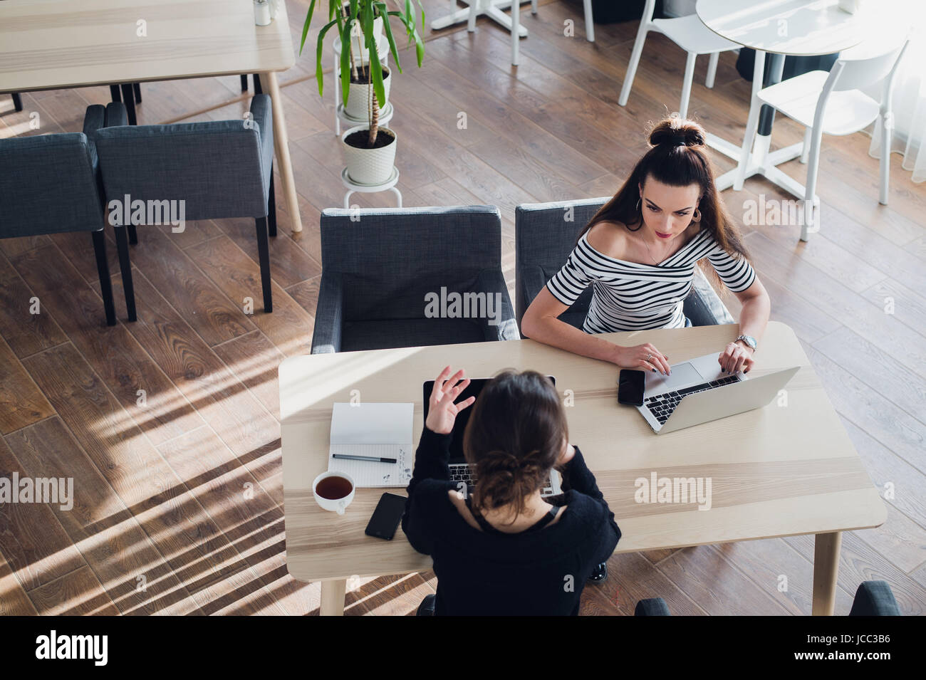 Overhead interview two women talking hi-res stock photography and ...