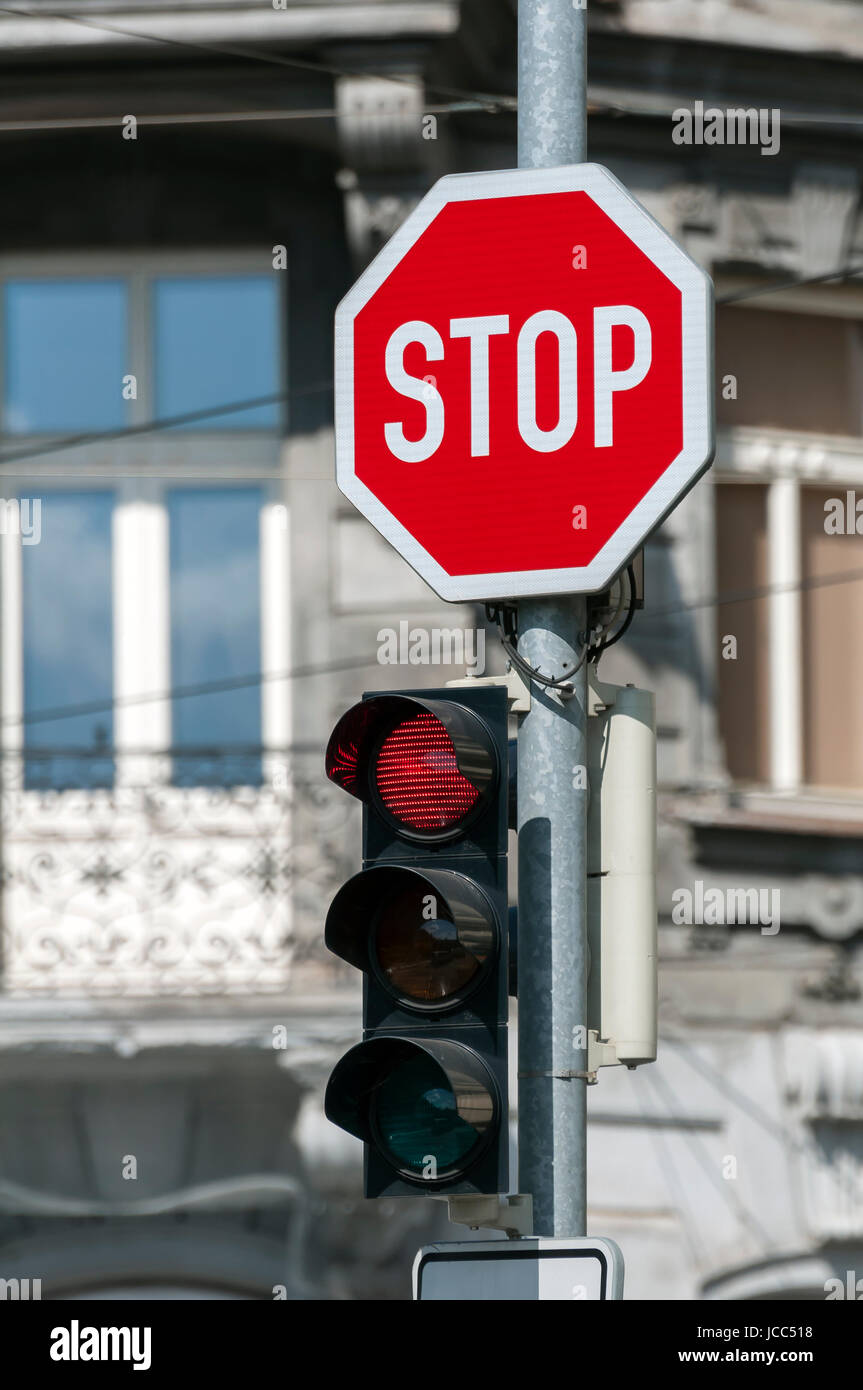 Red traffic light on and stop sign Stock Photo - Alamy