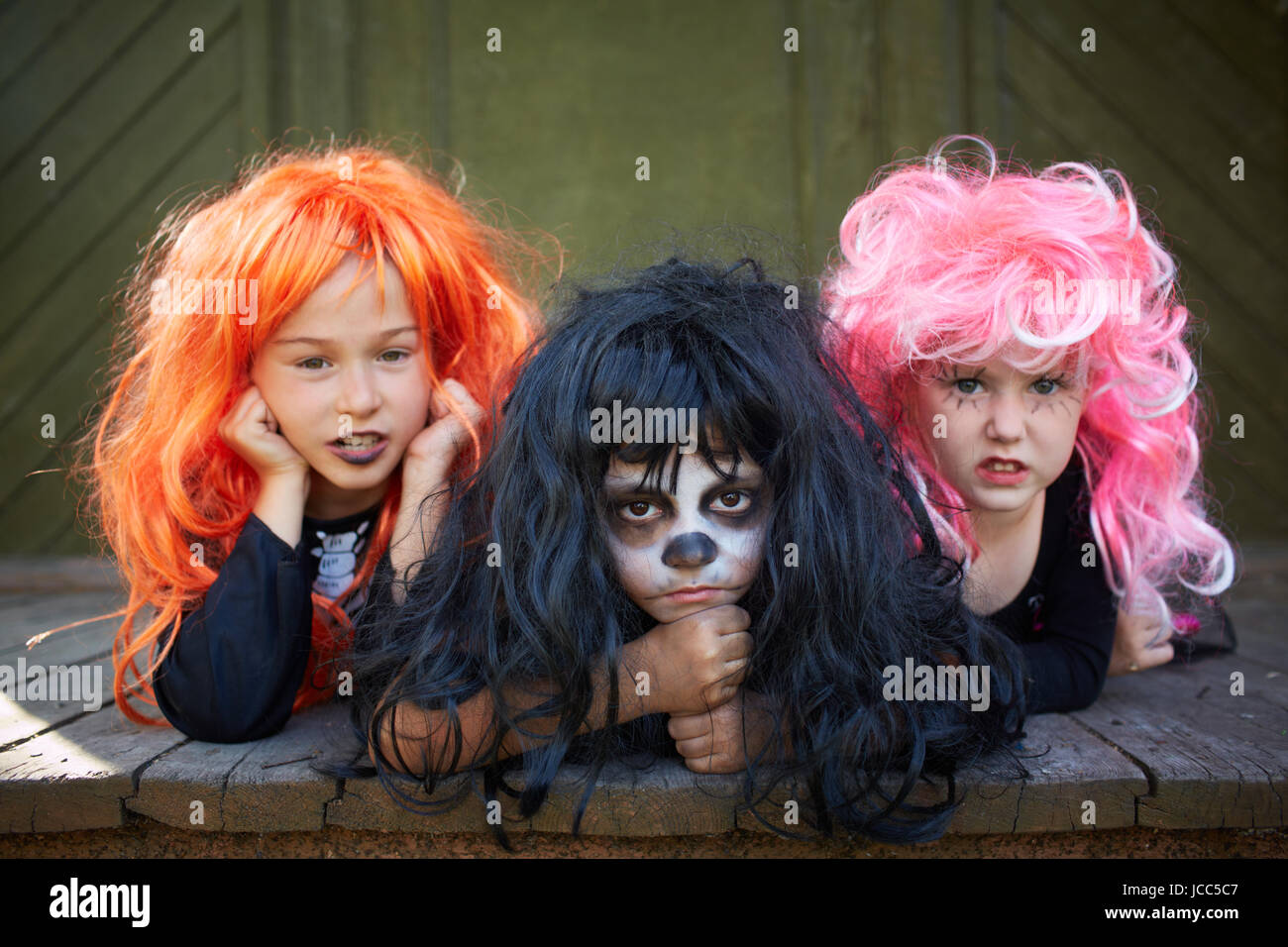 Three Halloween witches looking at camera sulkily Stock Photo - Alamy