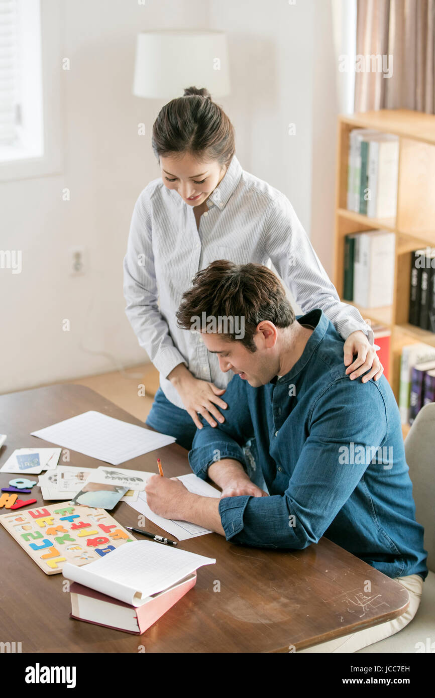 Smiling multicultural couple learning Korean Stock Photo - Alamy