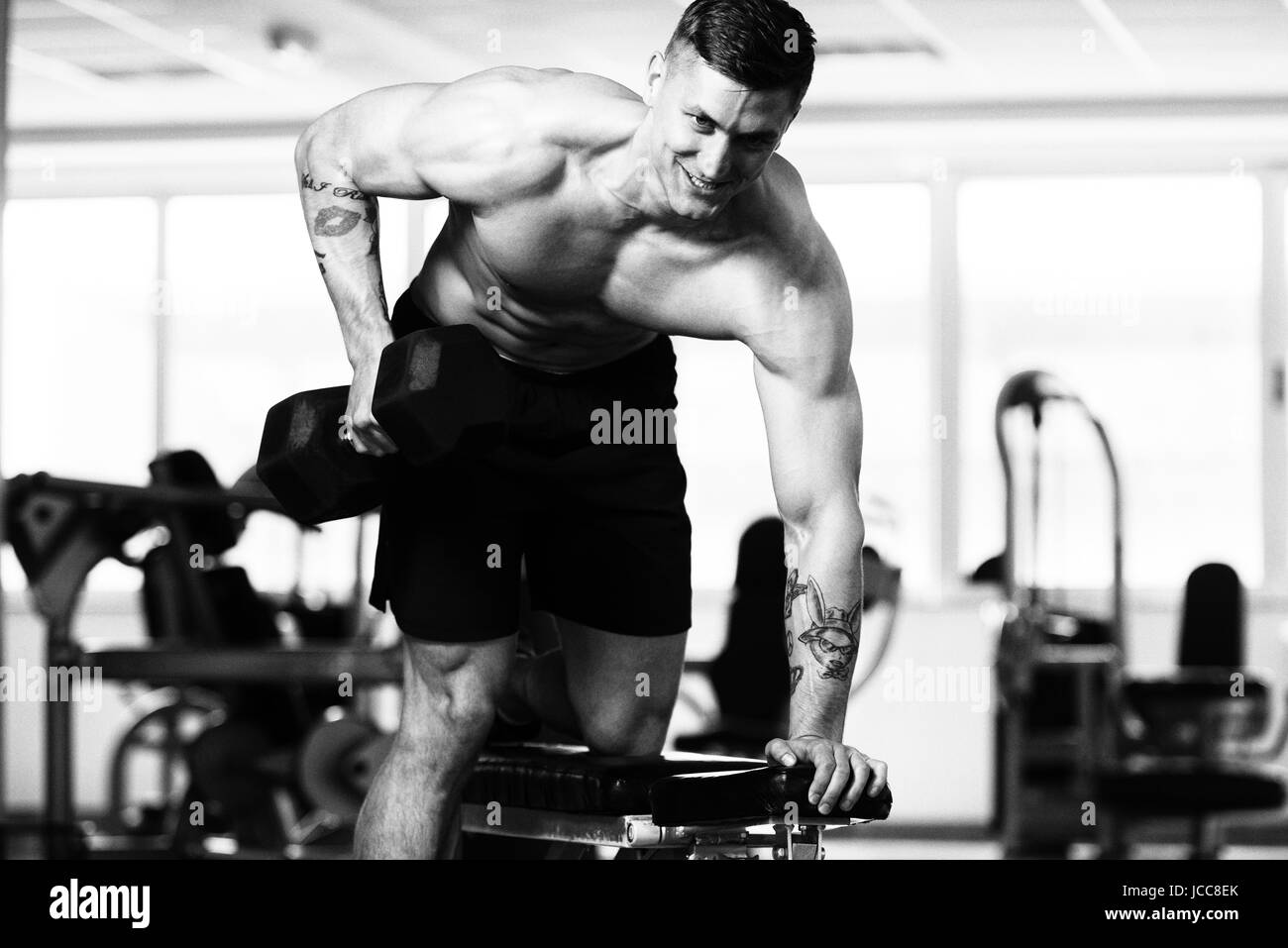 Man Working Out Back In A Gym - Dumbbell Concentration Curls Stock ...