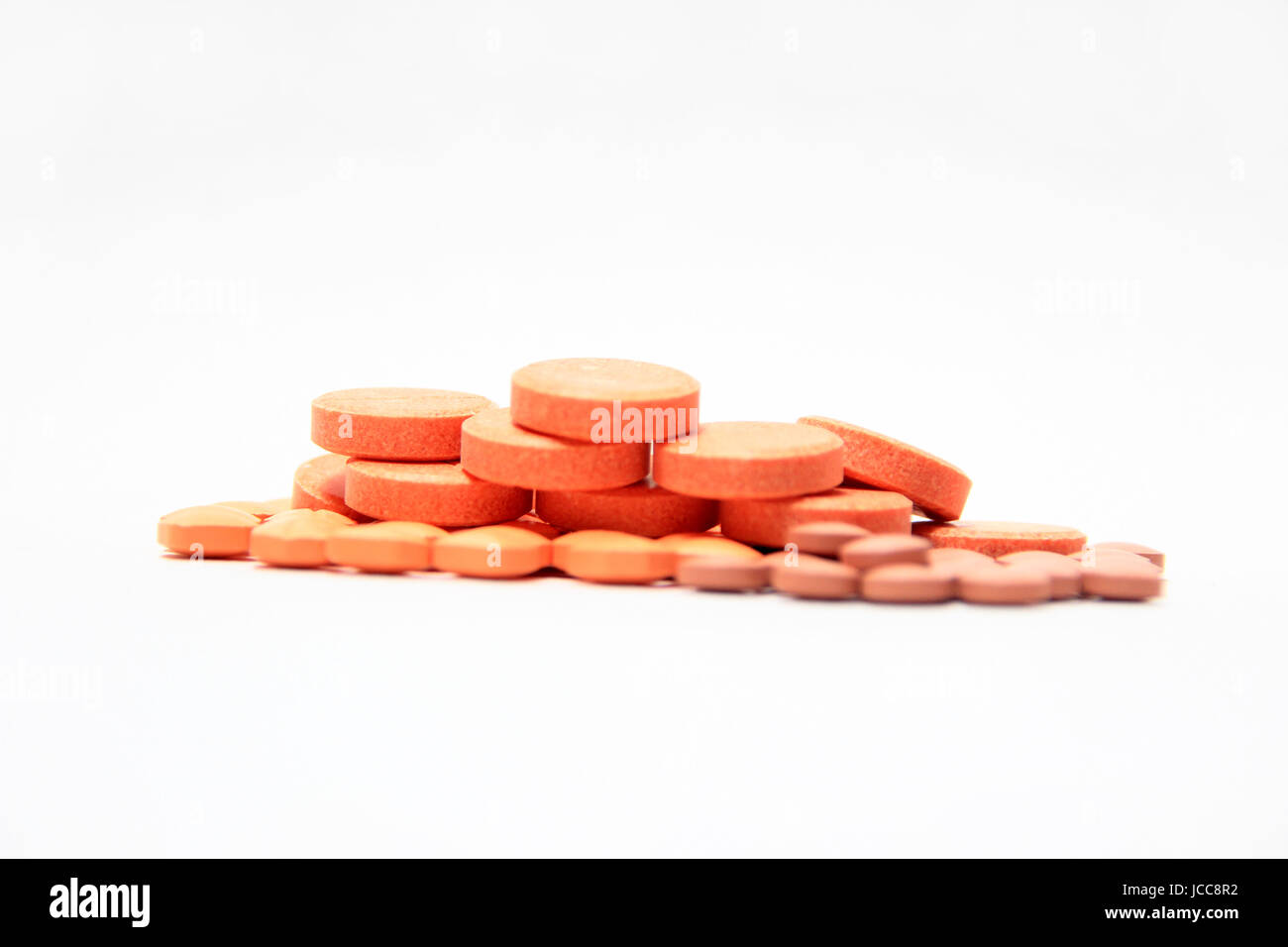 View of pink colored pills prescribed as medication, isolated on white ...