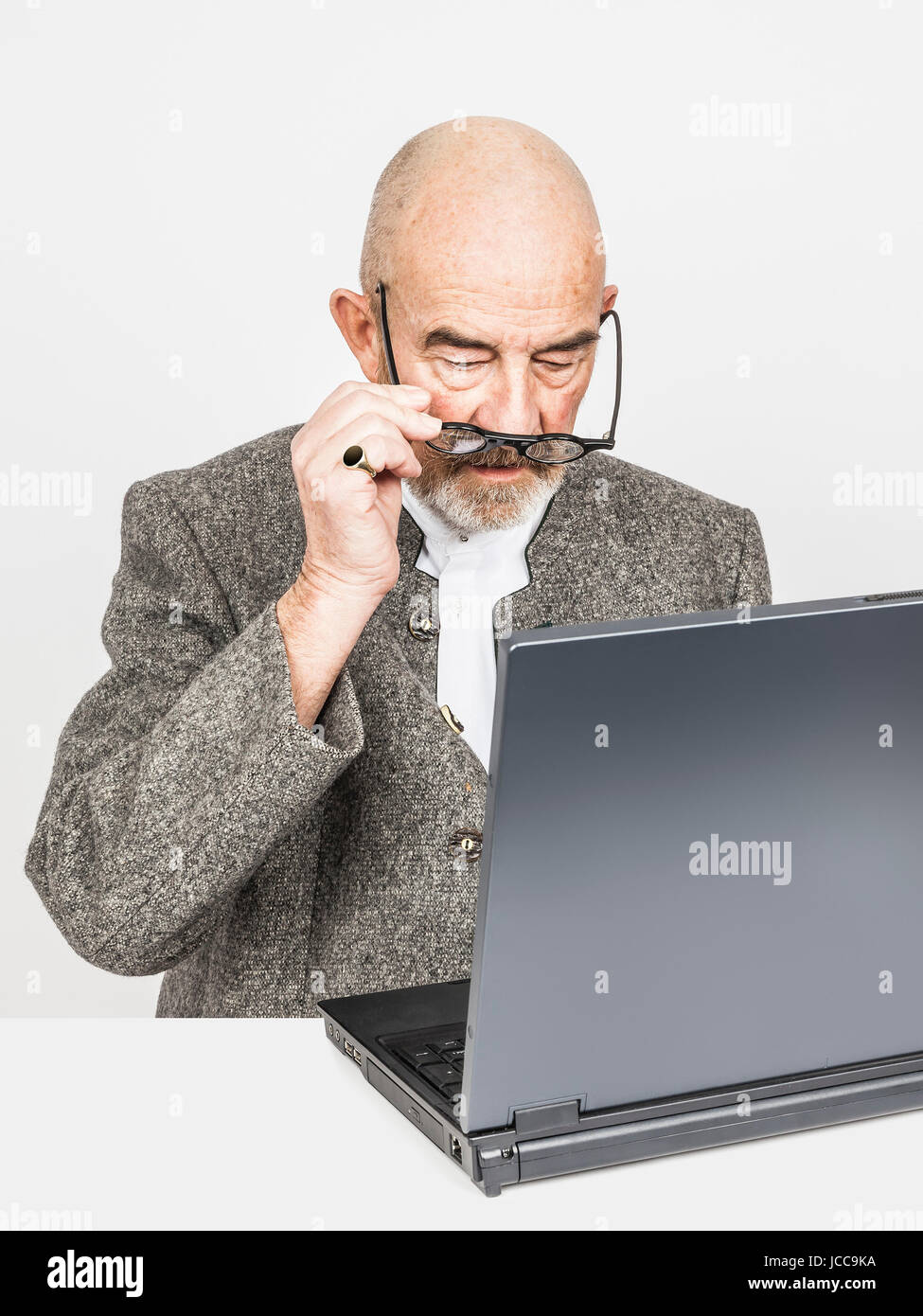 An old man with a grey beard and a computer Stock Photo - Alamy