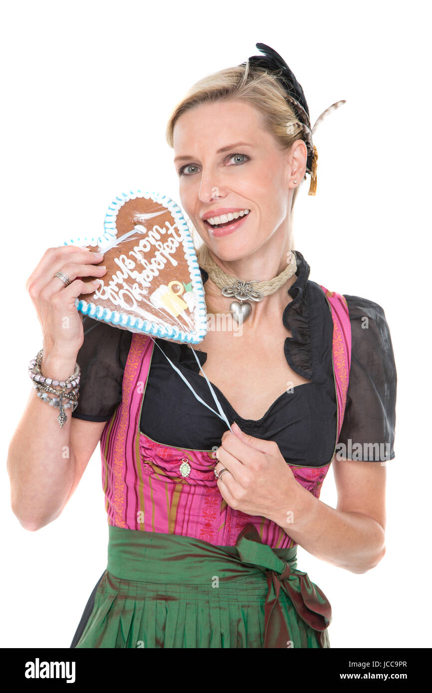 woman in dirndl with gingerbread heart Stock Photo - Alamy