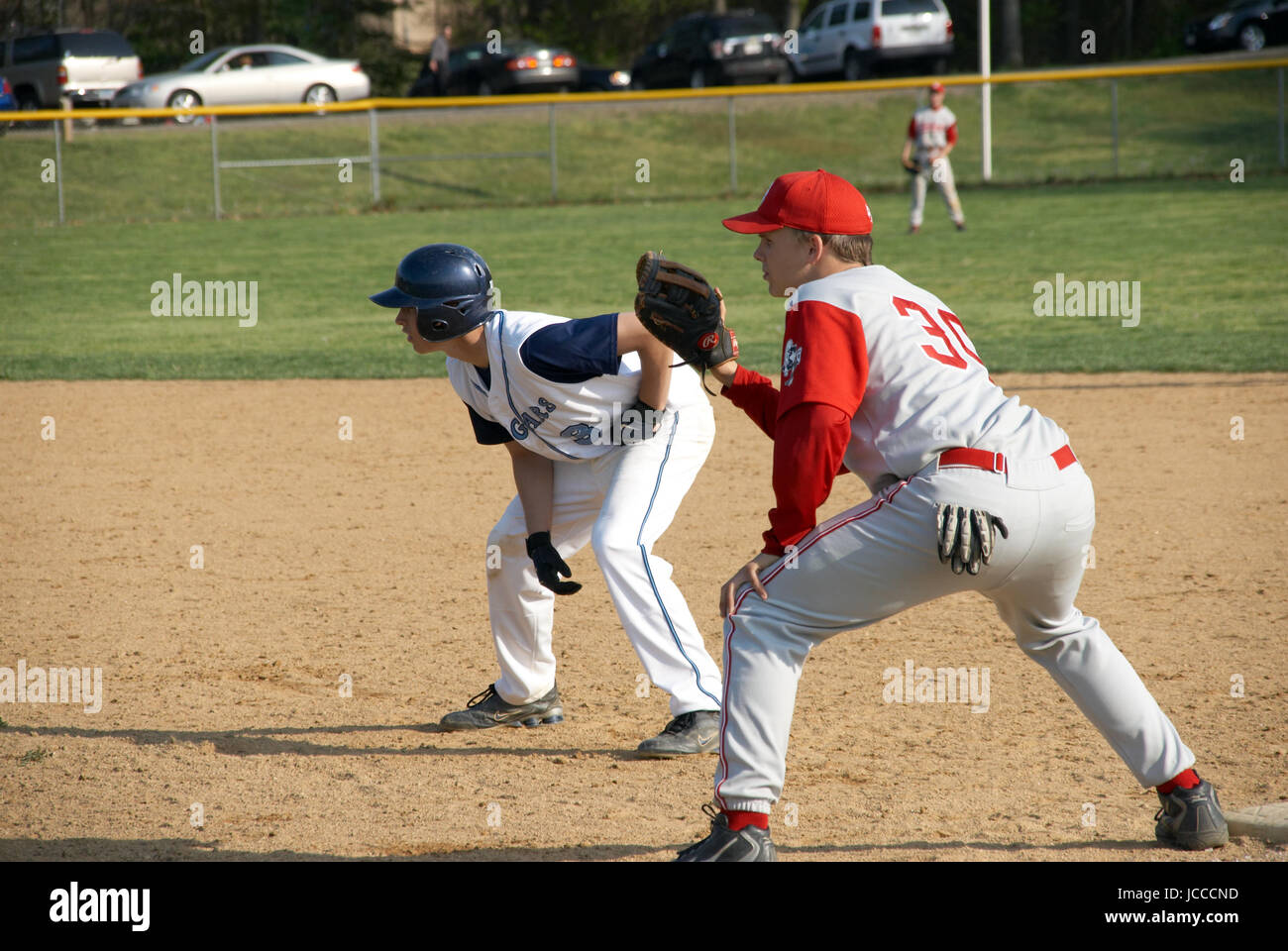 1st baseman holding runner in a high school baseball Stock Photo - Alamy