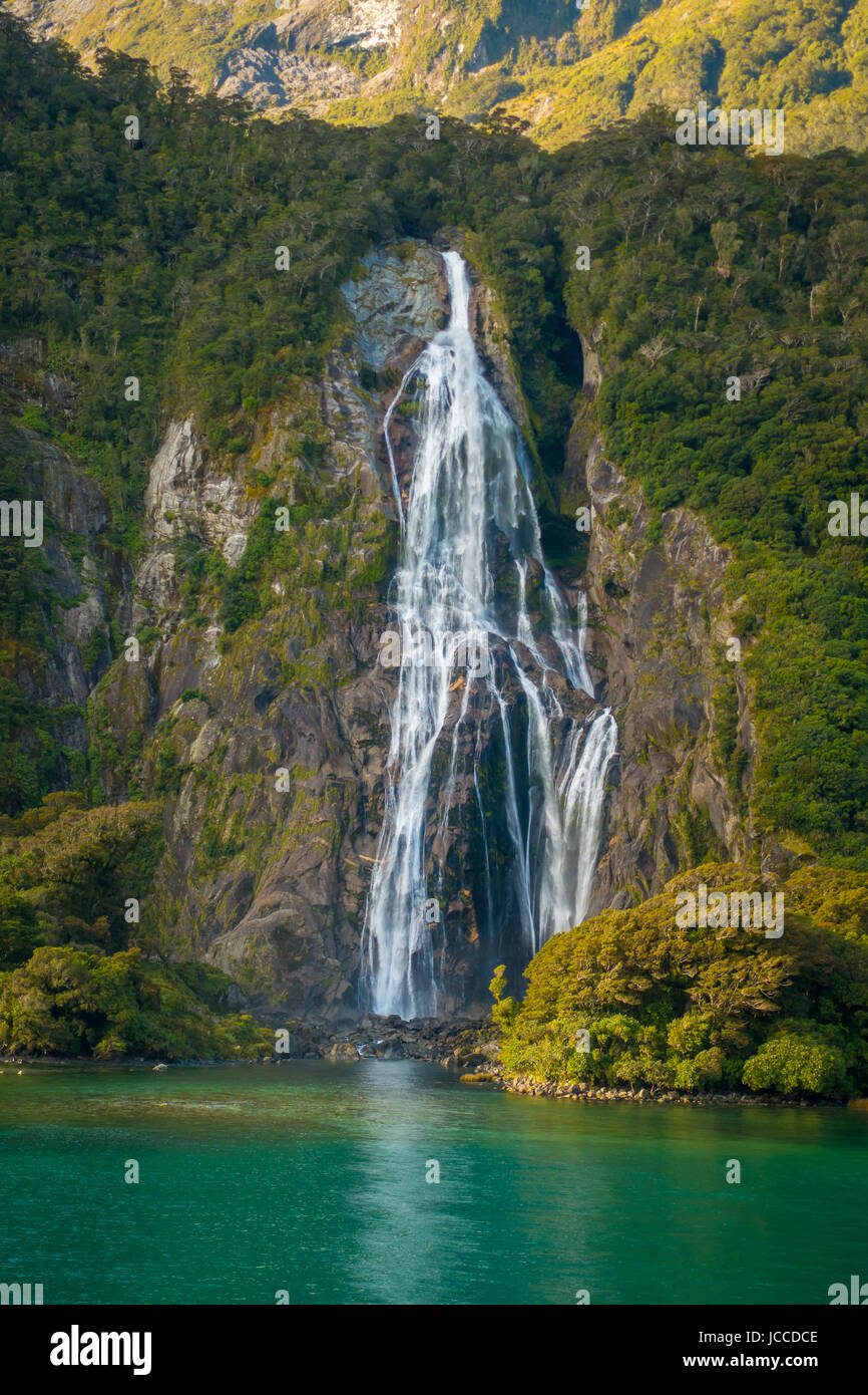 The view of a waterfall in Milford Sound, the most popular part of ...
