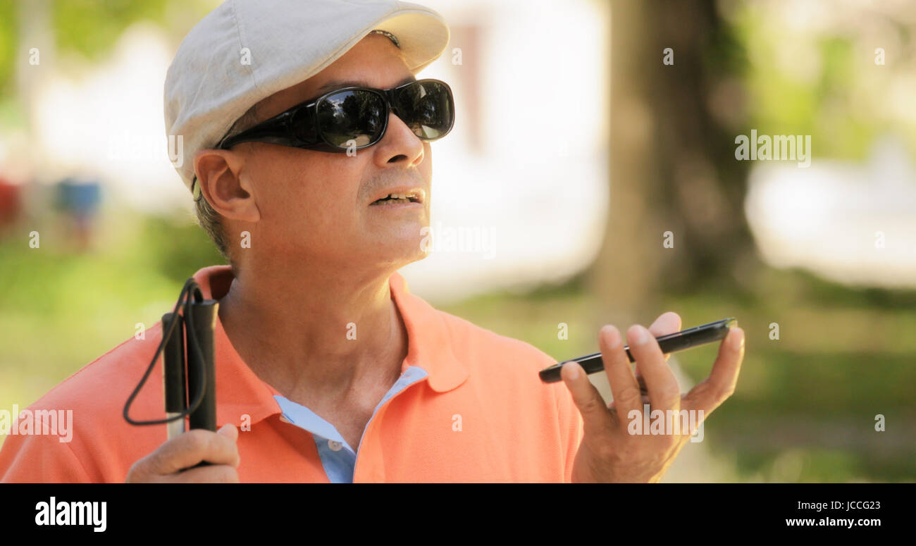 Hispanic blind man with disability. Visually impaired man using Digital ...