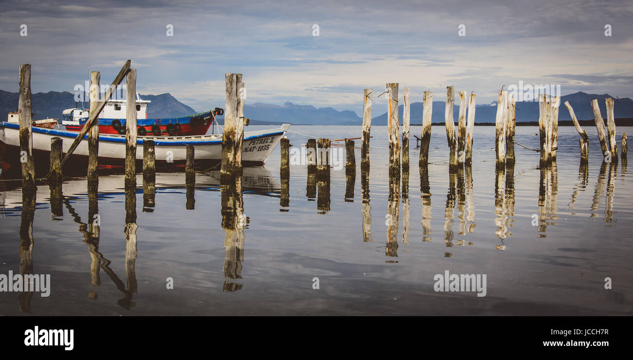 Old boat & dock in Puerto Natales Stock Photo - Alamy