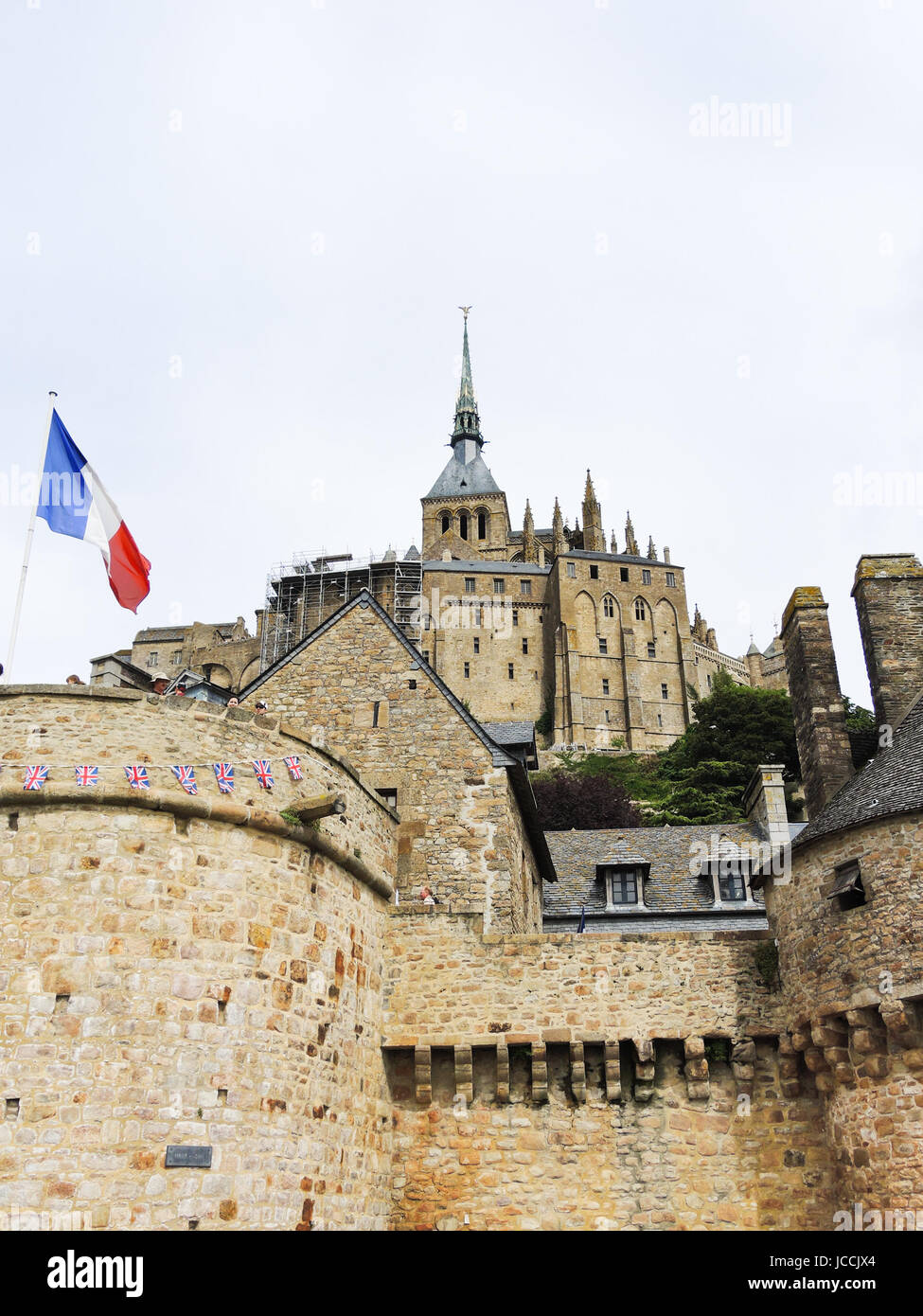 flag, stone walls and abbey mont saint-michel in Normandy, France Stock ...