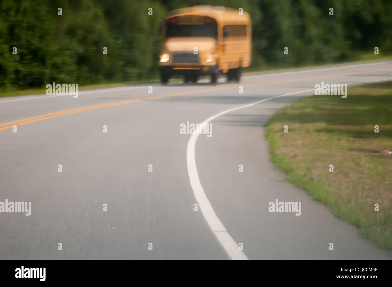 blurry abstract view of school bus driving on road Stock Photo - Alamy