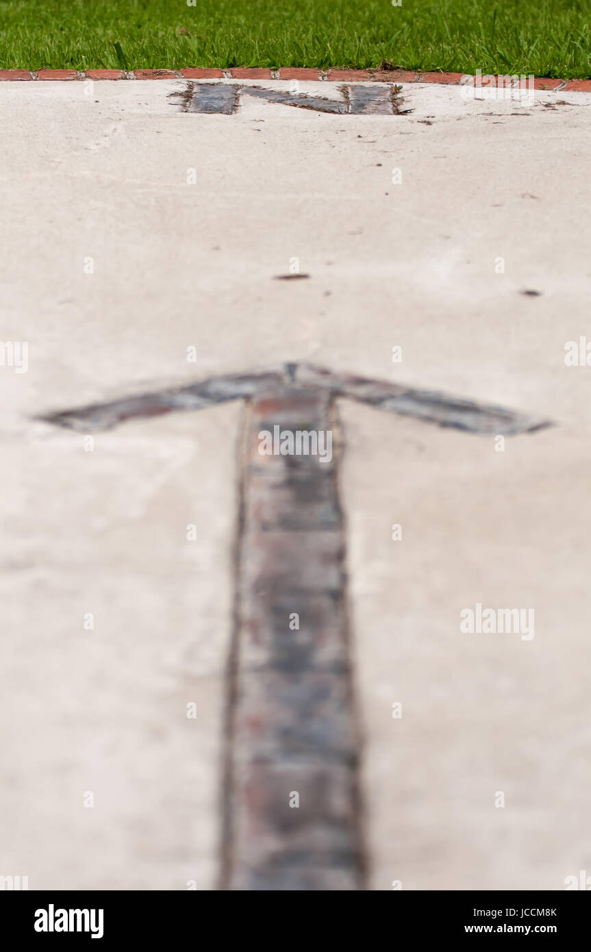 brick paver north arrow compass embedded in concrete Stock Photo - Alamy