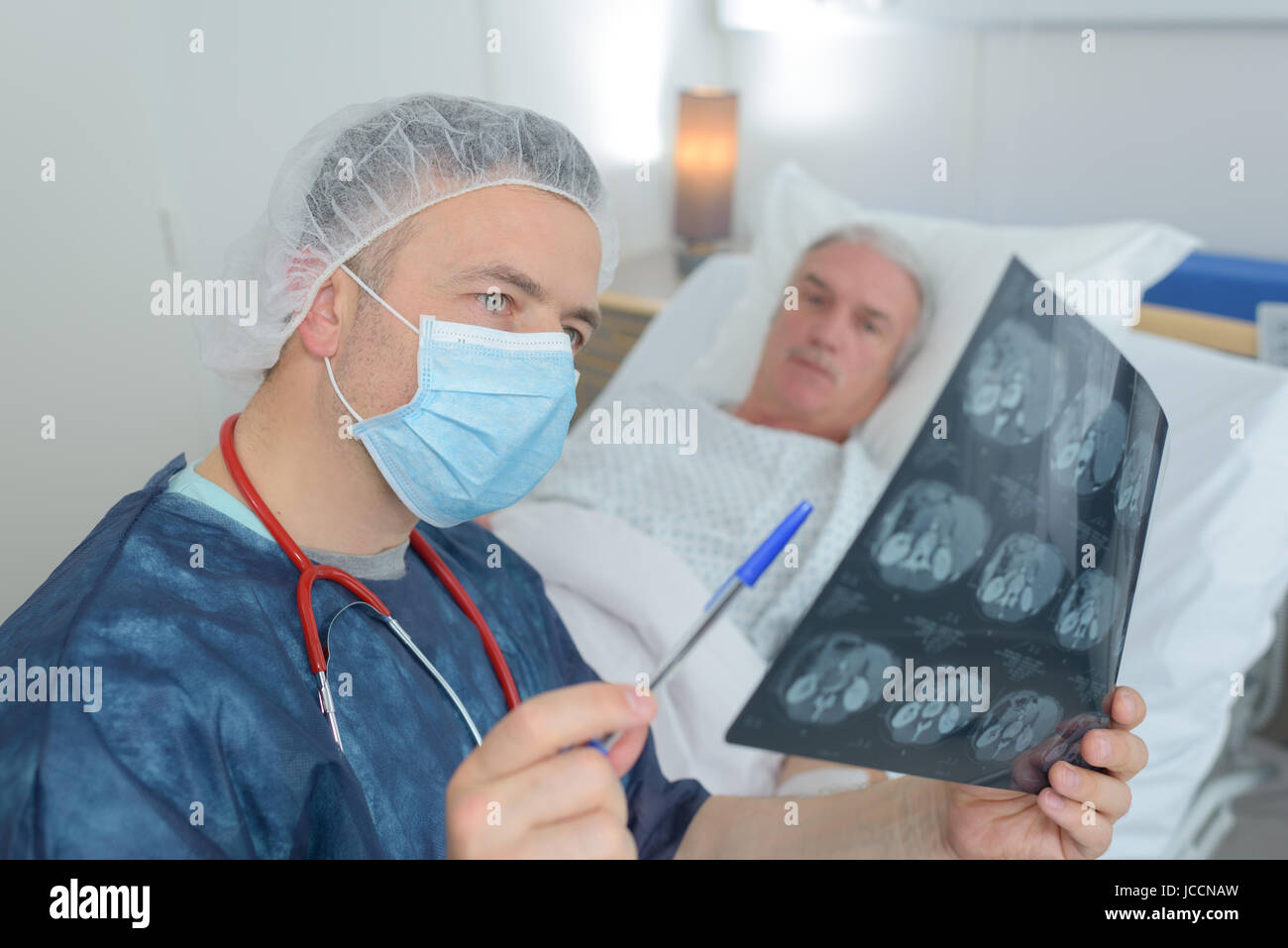 the doctor checking x ray film with patient Stock Photo - Alamy
