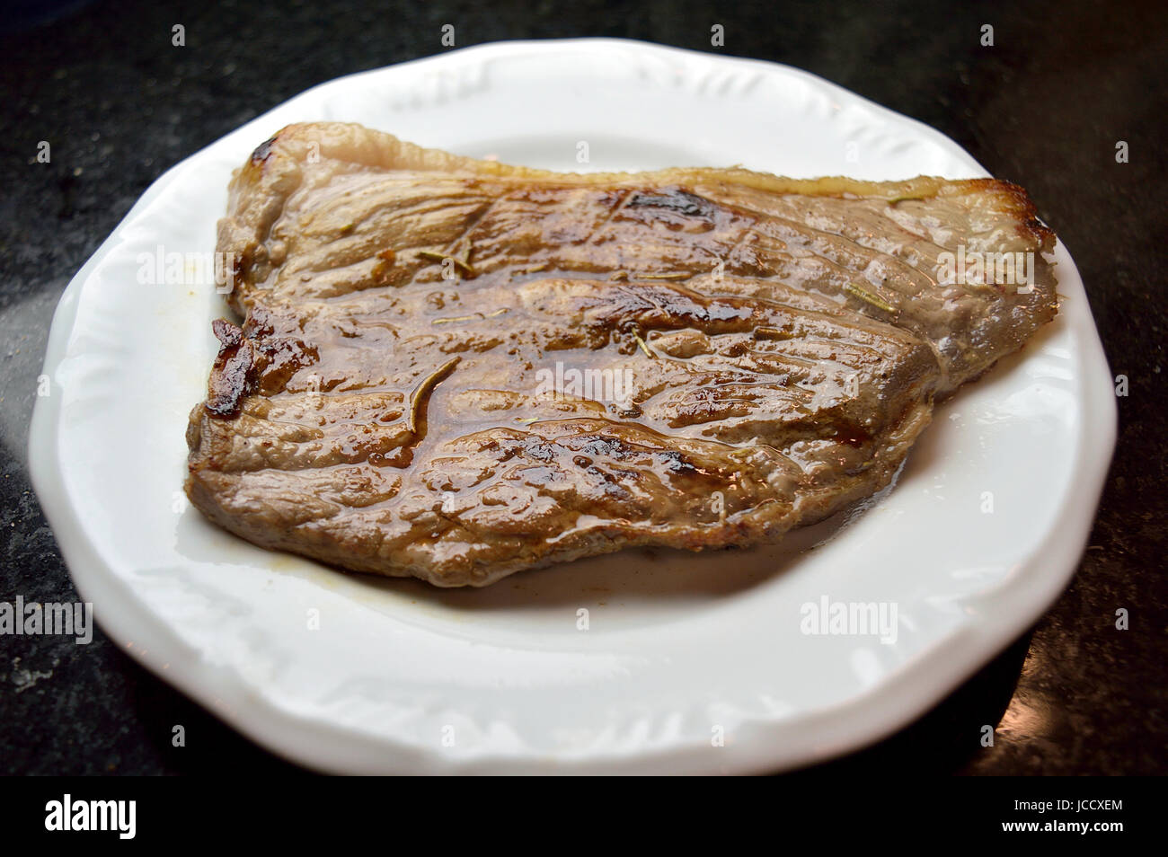 Nice piece of red meat beef on a plate ready to eat Stock Photo - Alamy