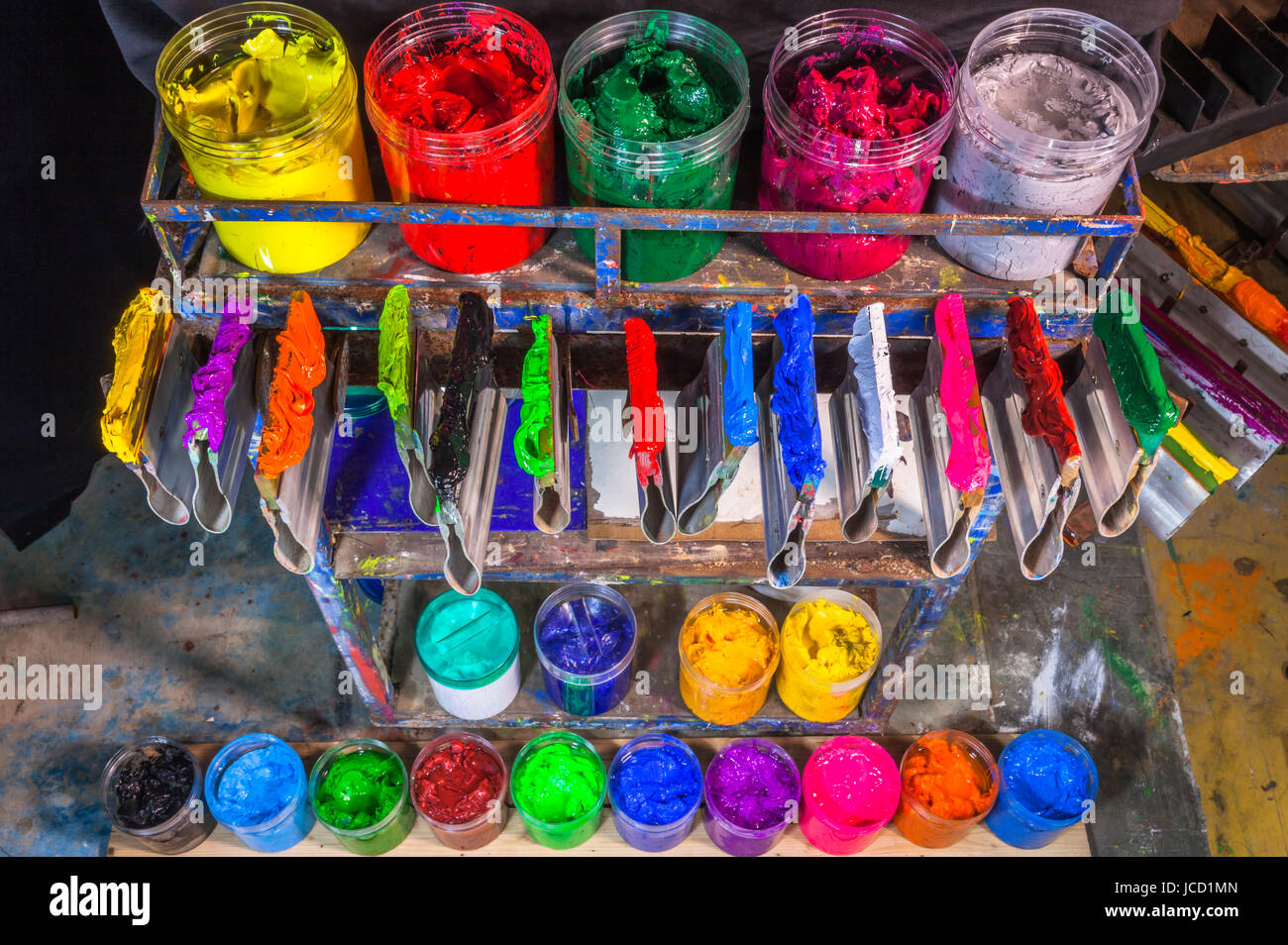 ink on rubber handle hang on place above plastisol ink in cans ready ...