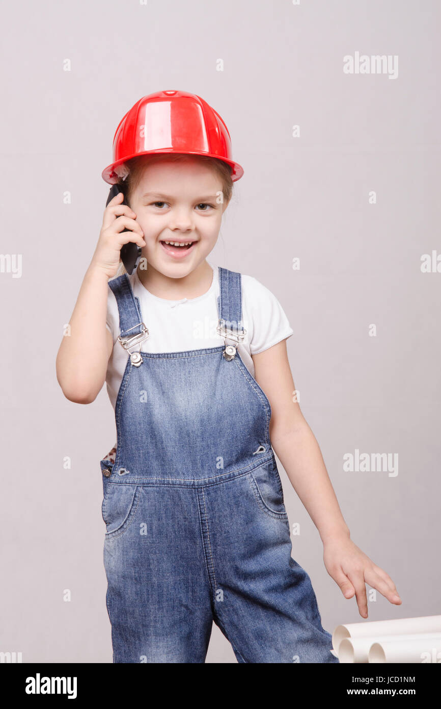 Girl playing Builder talking on the phone Stock Photo - Alamy