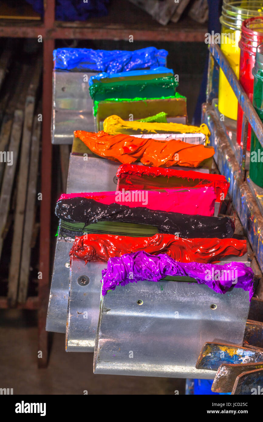 ink on rubber handle hang on place above plastisol ink in cans ready ...