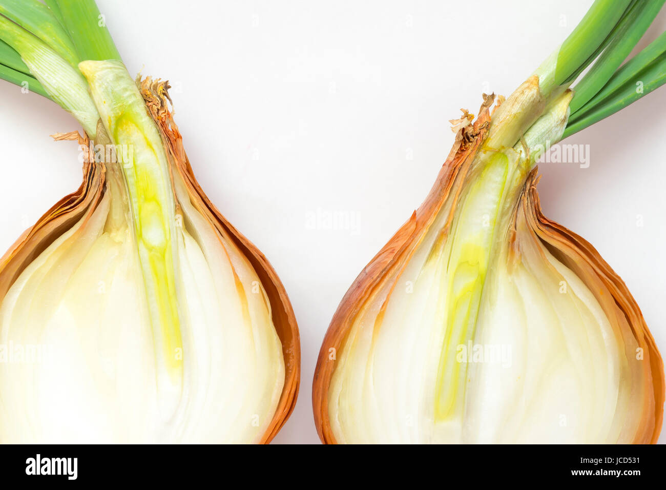 Onions, cut in half on a white background Stock Photo - Alamy